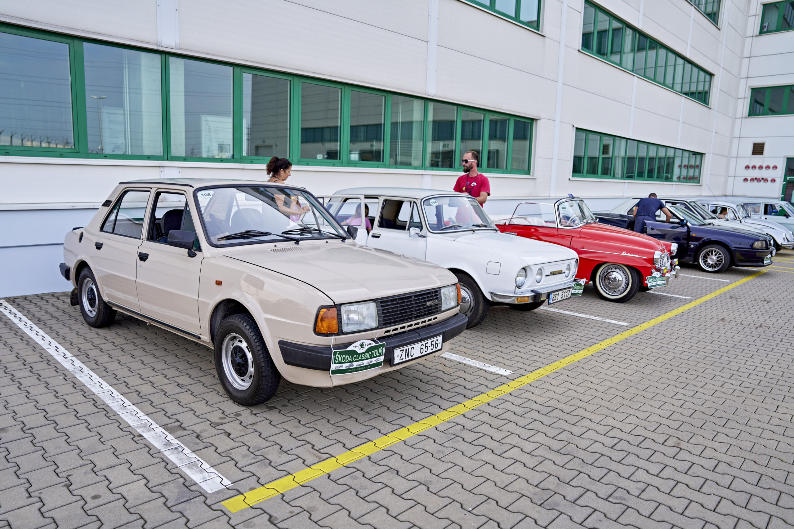 Cars in the car park in front of the Škoda Parts Center - Škoda Storyboard